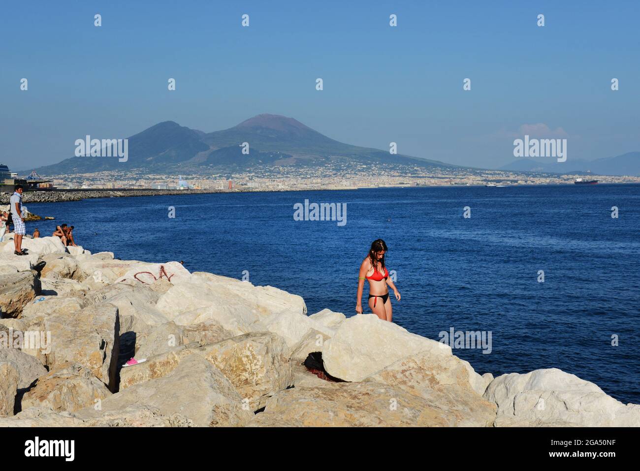 Sunbathing at the seafront in Naples, Italy Stock Photo - Alamy