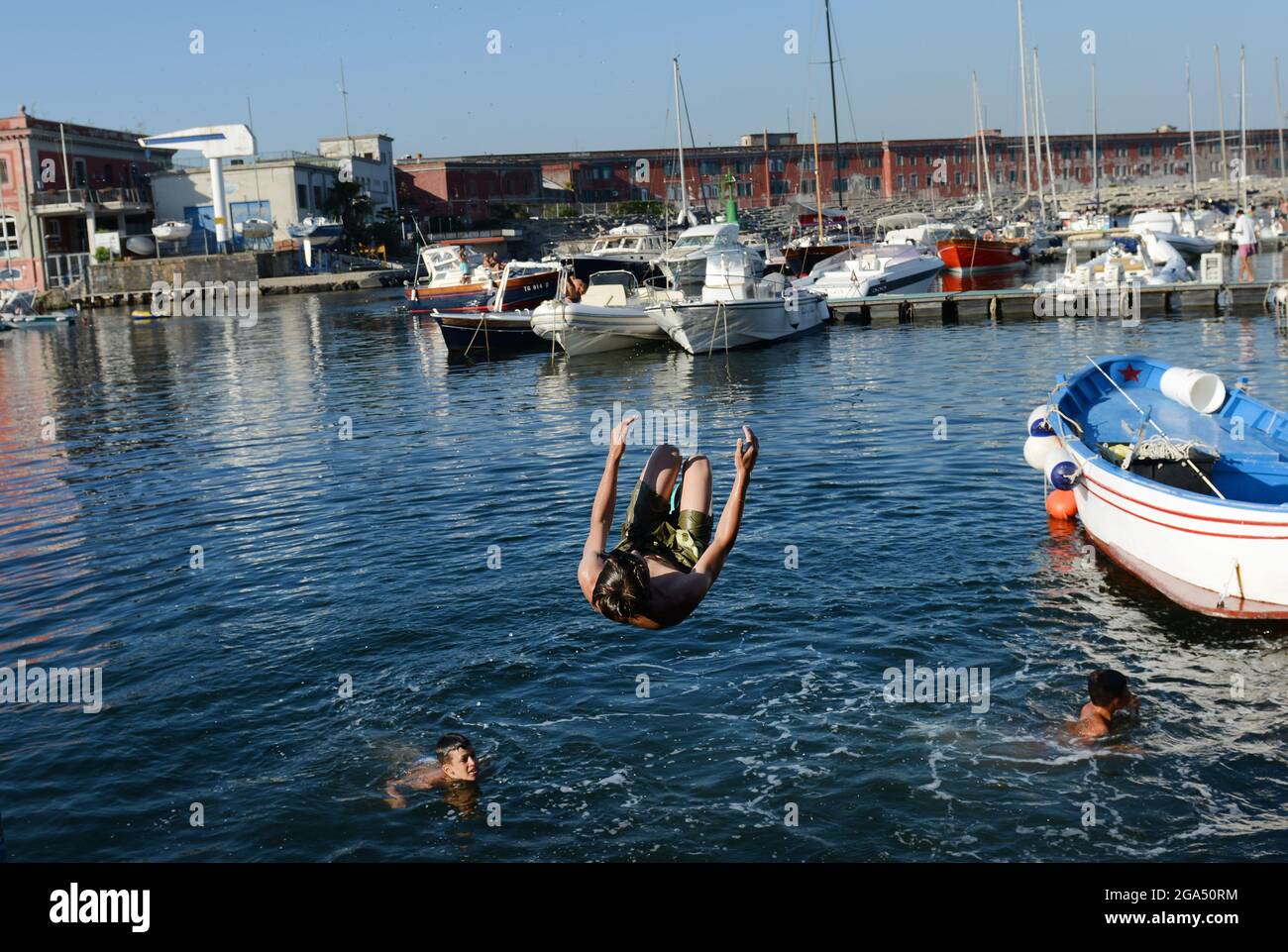 Italian children jumping into the water at the Porticciolo Molosiglio ...
