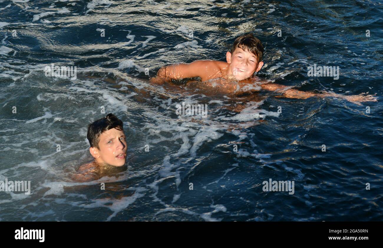 Italian children jumping into the water at the Porticciolo Molosiglio ...
