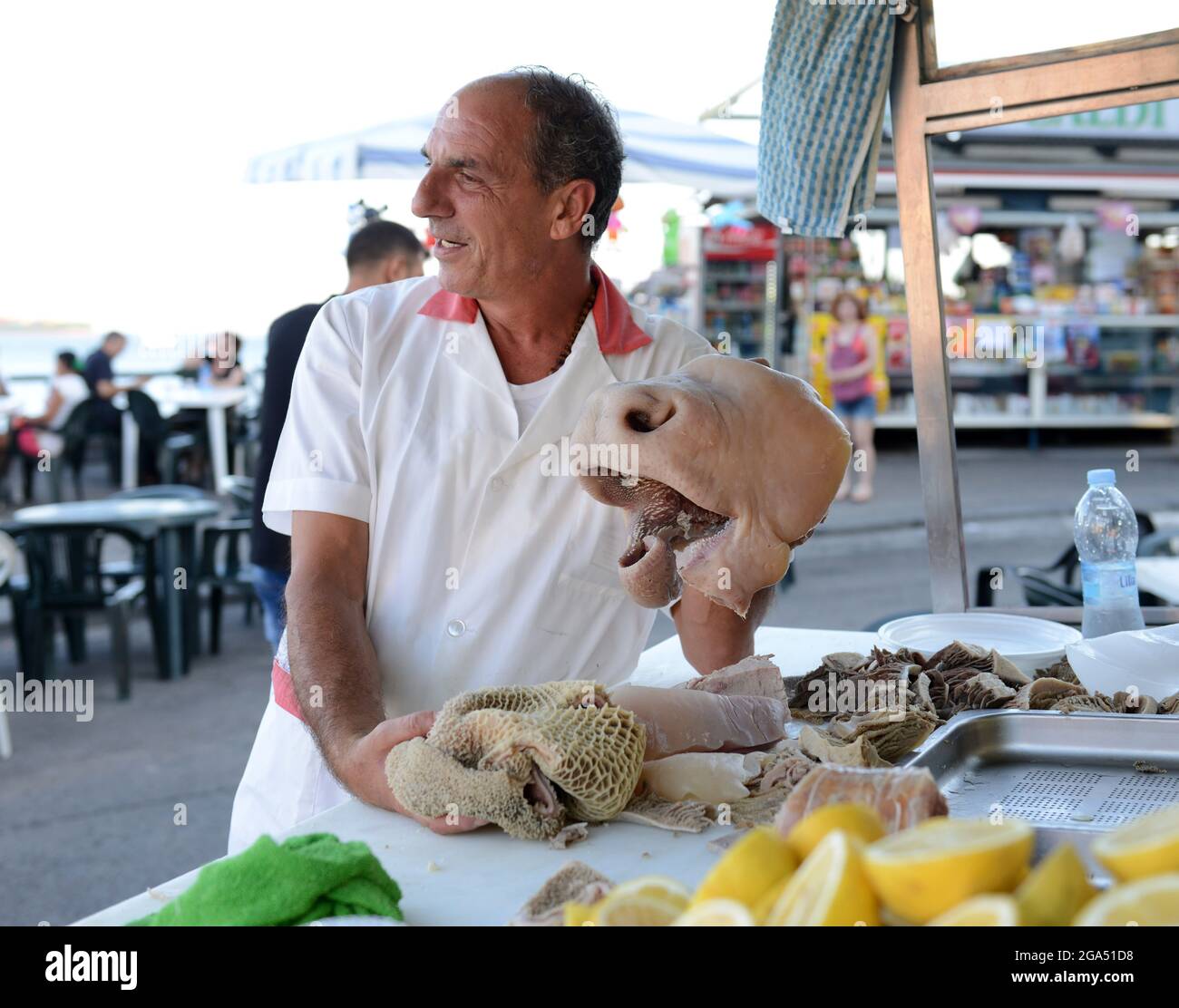 An Italian cook holding cow's internal organs Stock Photo - Alamy