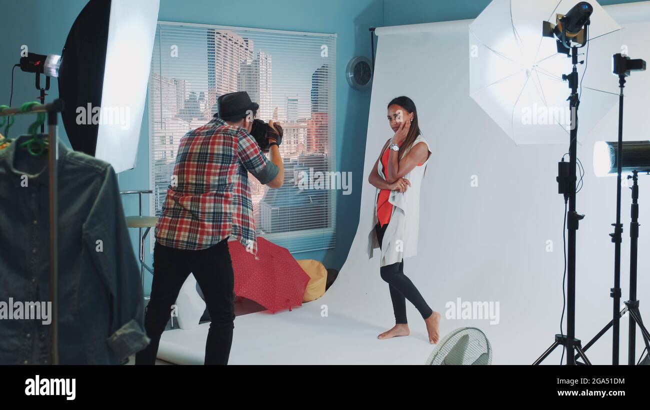 Behind the scenes on photo shoot: photographer taking photos of ...