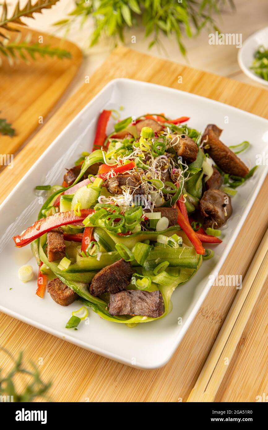Asian style salad with beef cubes decorated with sprouts Stock Photo ...