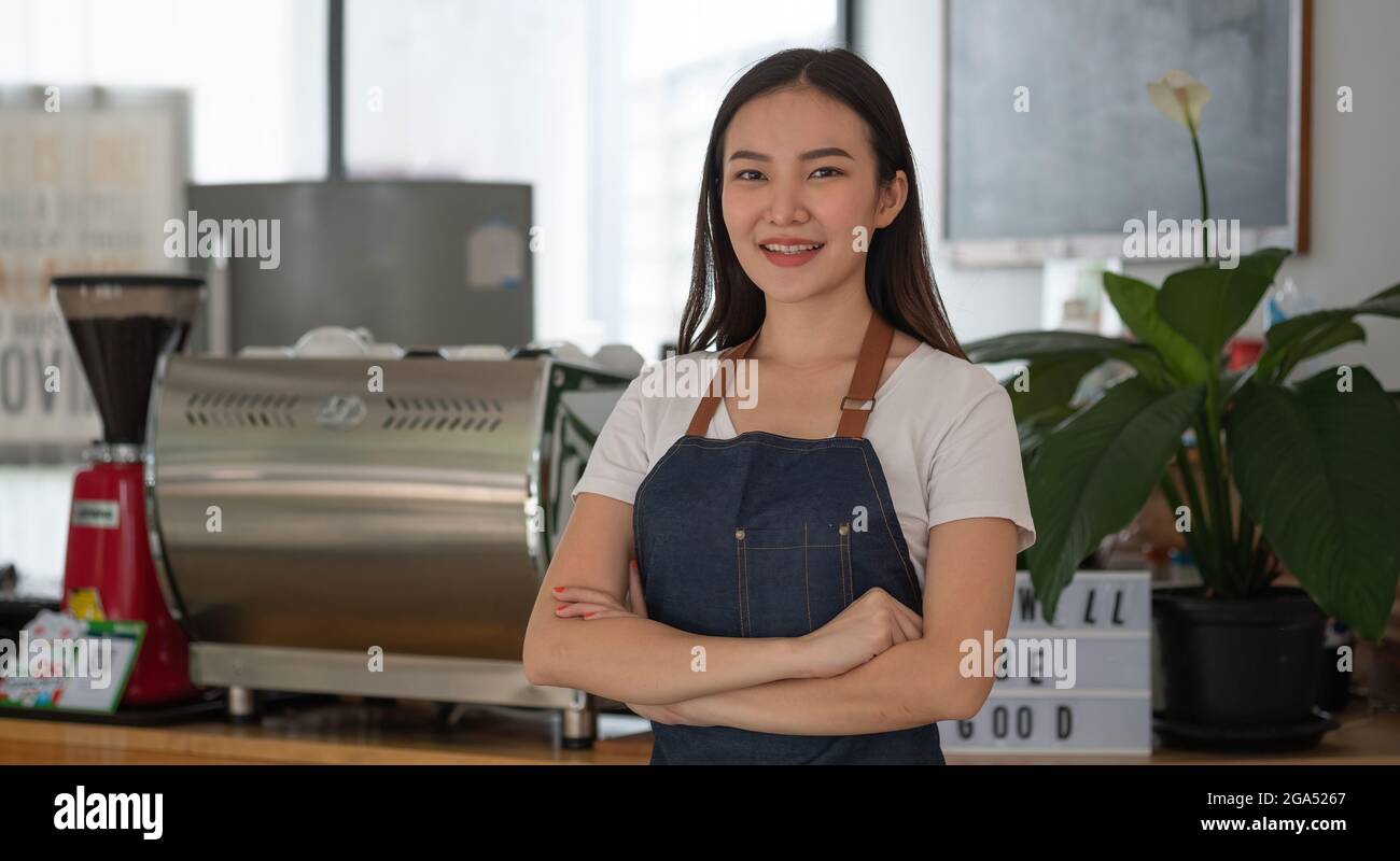 Beautiful asian woman store owner with standing in her coffee shop ...