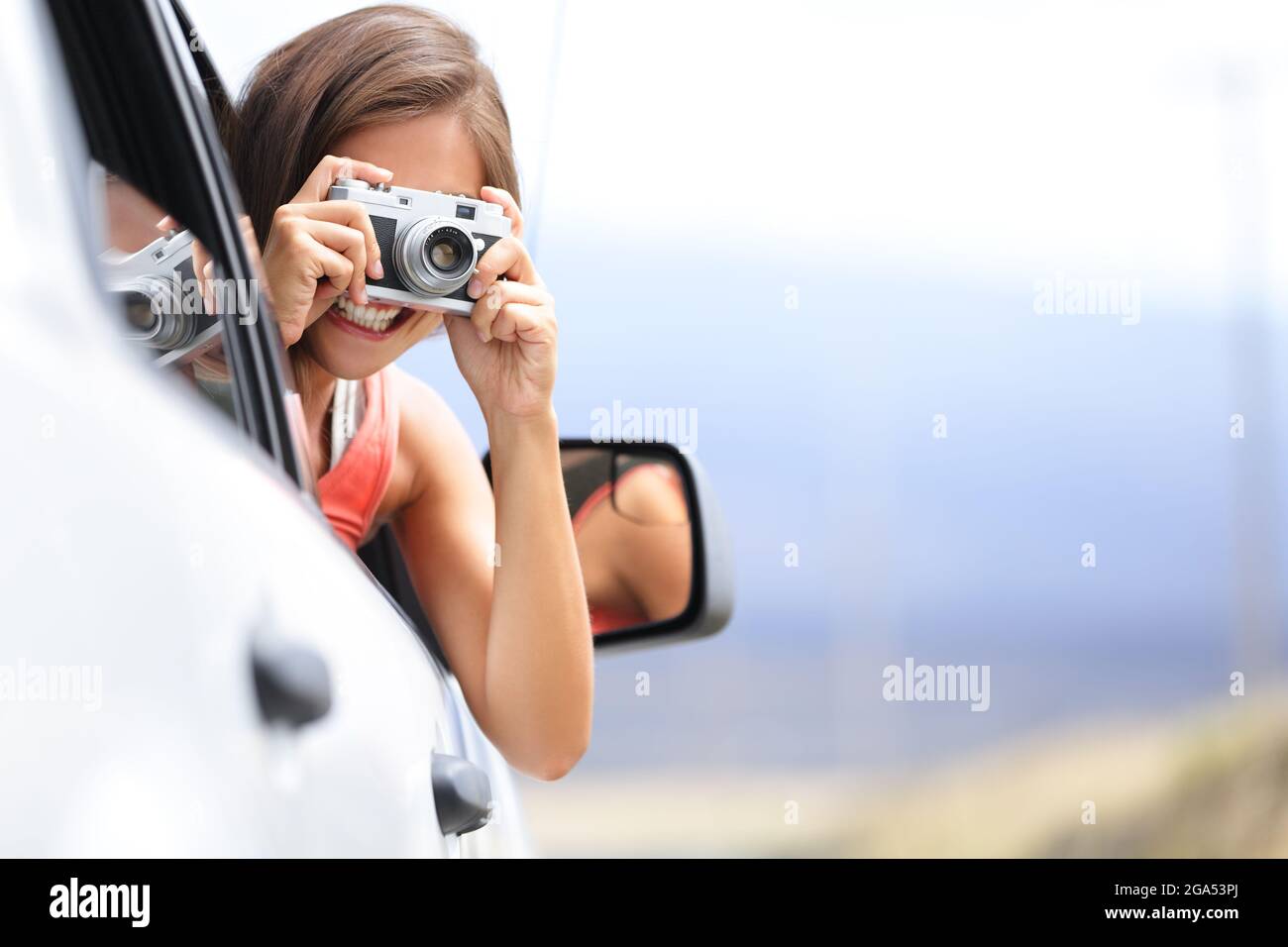 Woman tourist taking photo in car with camera Stock Photo - Alamy