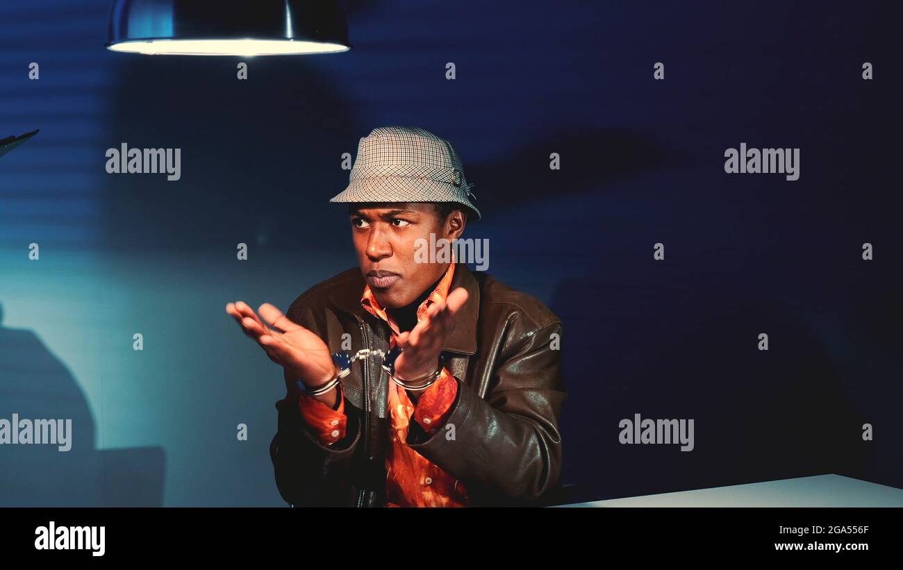 Young black man in handcuffs refusing accusation in his address during ...