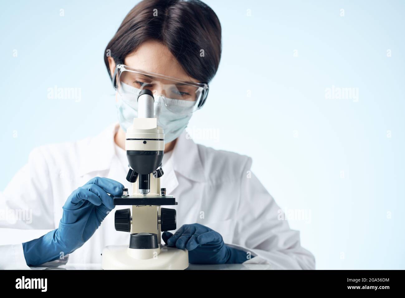 Woman in white coat microscope biotechnology science research Stock ...
