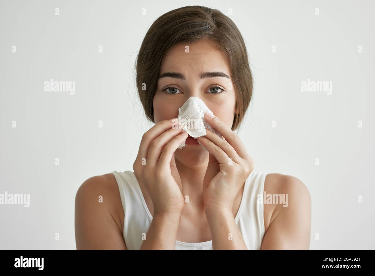 sick woman in white tank top handkerchief runny nose health problems ...