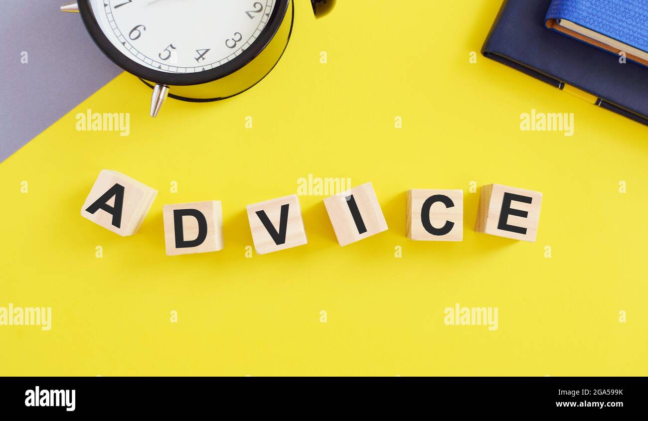 The Word ADVICE concept made with building blocks, yellow background ...