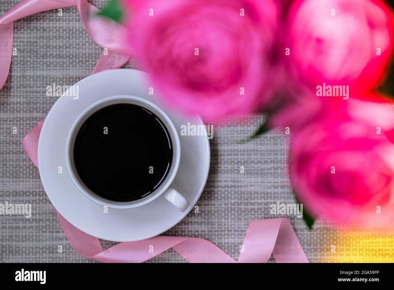 Cup of coffee and pink roses. Holiday concept, bouquet of roses for a ...