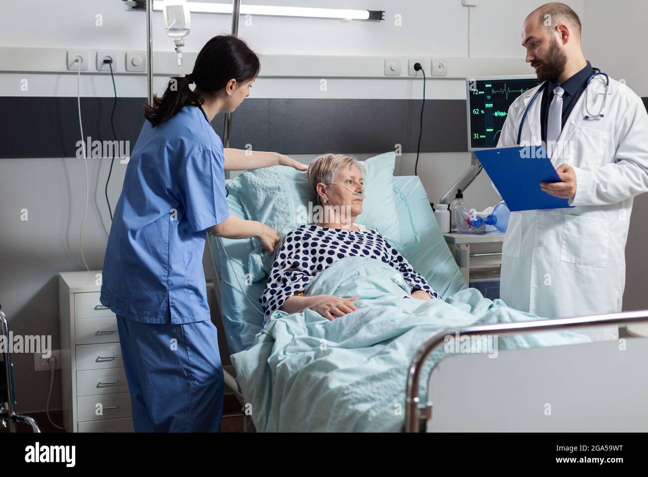 Medical staff checking senior woman health condition in hospital with ...