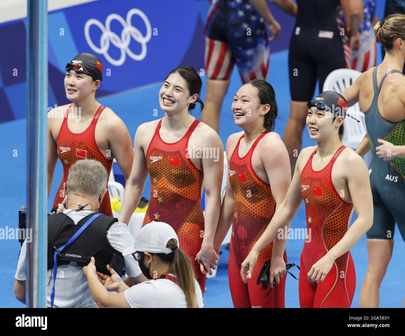 Swimmers of the Chinese women's 4x200-meter freestyle relay team celebrate after winning in a ...