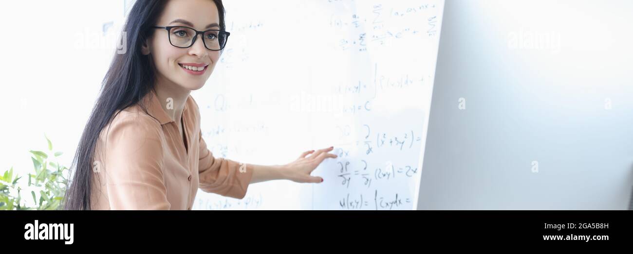 Woman teacher showing math formulas in computer screen Stock Photo - Alamy
