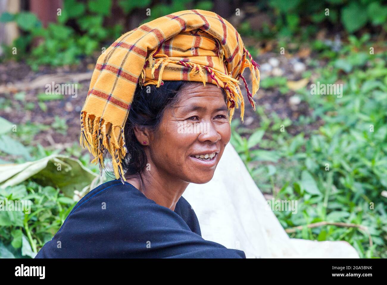 Market trader from Pa'o (Pa-o) hill tribe wearing orange turban selling ...