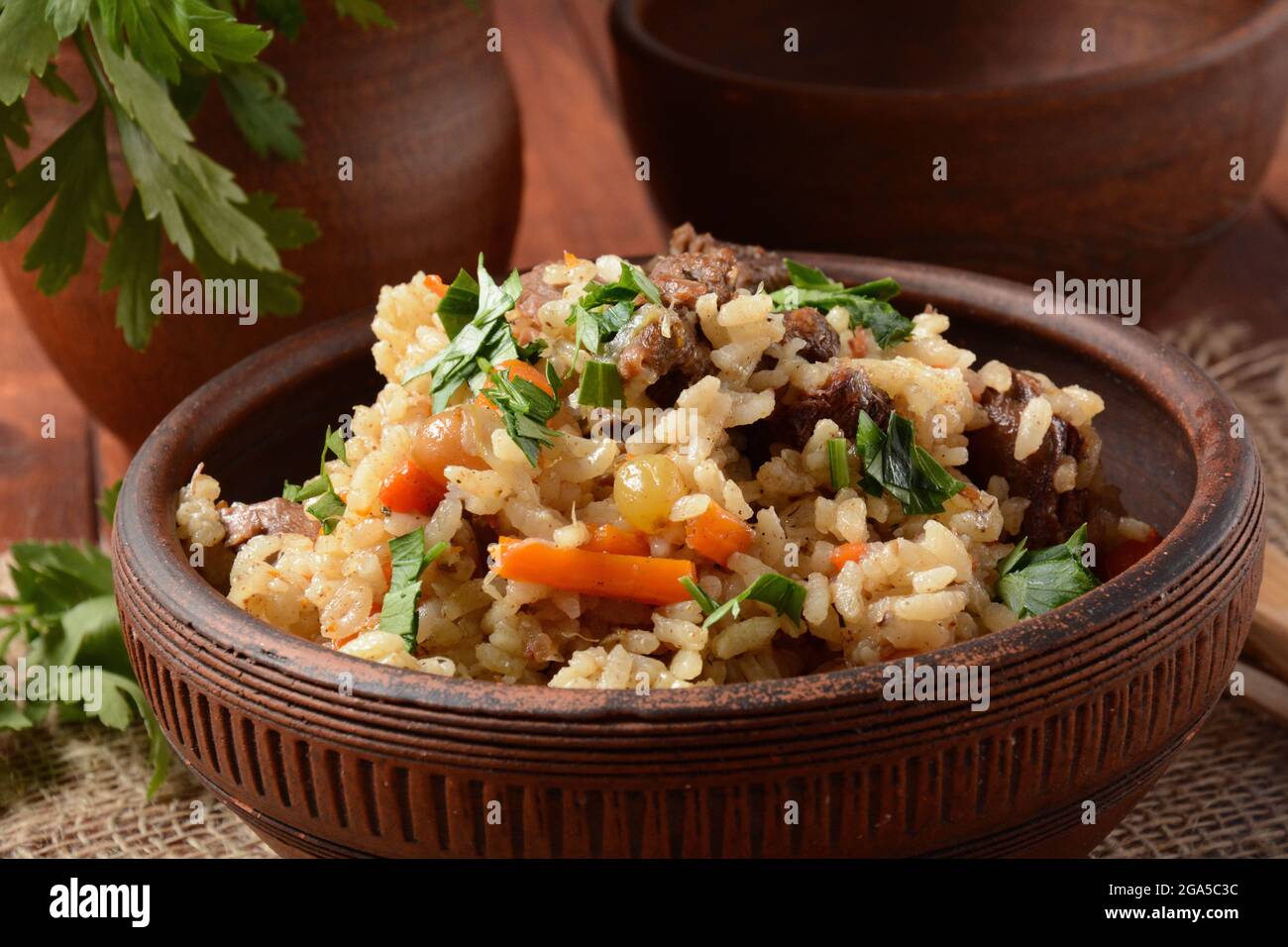 Fried and stewed beef meat with rice. Uzbek cuisine pilaf (plov Stock ...