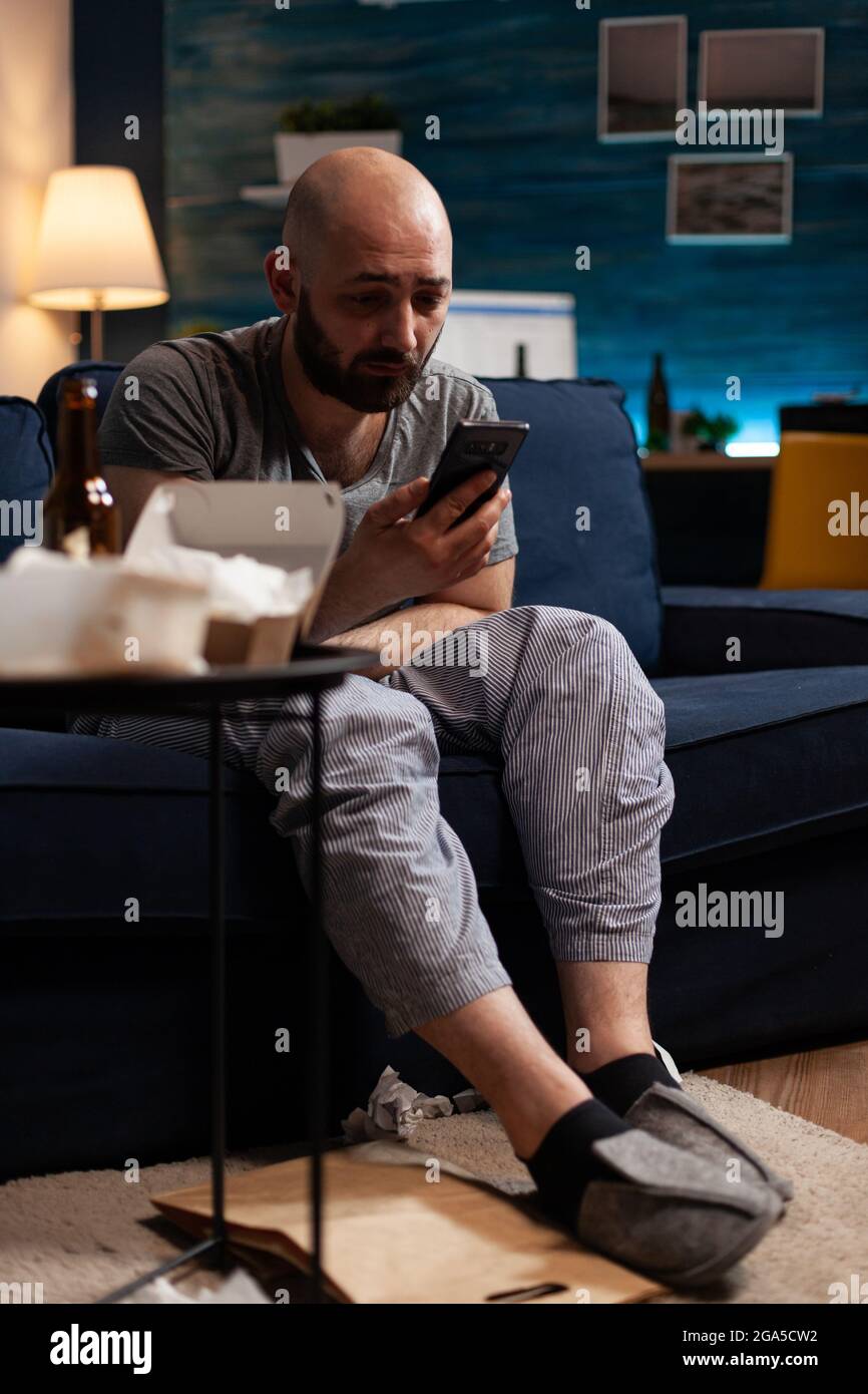 Depressed, worried man reading renter notification for unpaid bank ...