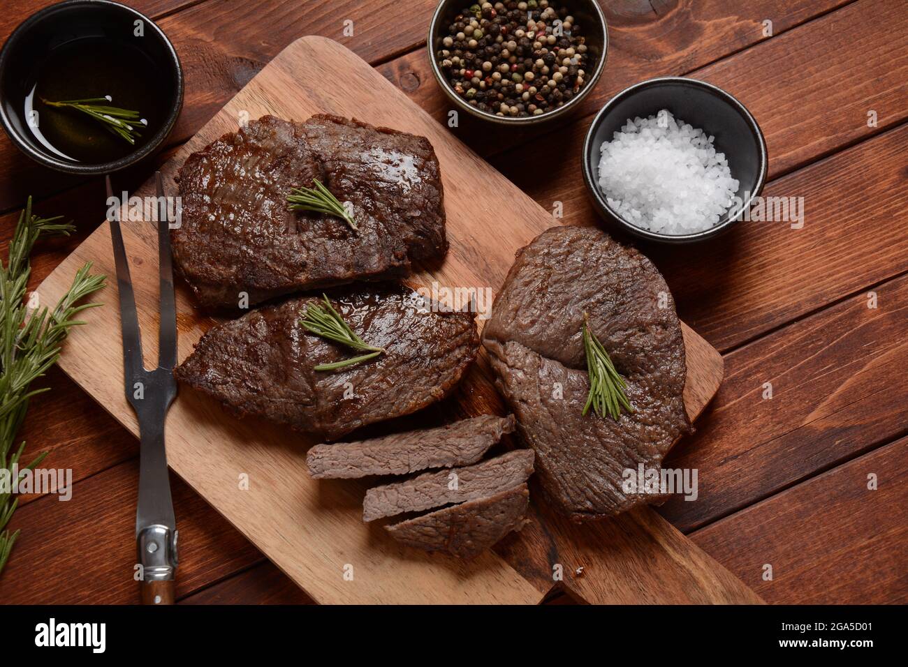 Grilled juicy beef steak with rosemary, fried meat, close-up. Top Blade ...