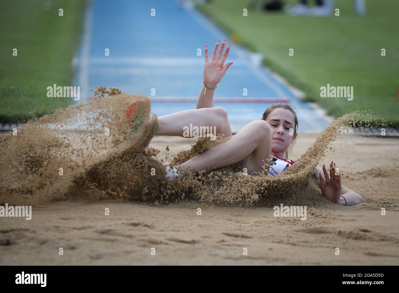 ISTANBUL, TURKEY - JUNE 13, 2021: Undefined athlete long jumping during ...