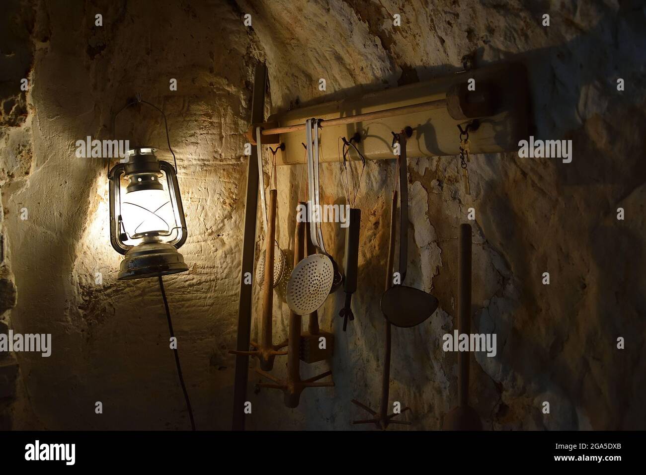 Lamp hanging in the cave with other instruments Stock Photo - Alamy