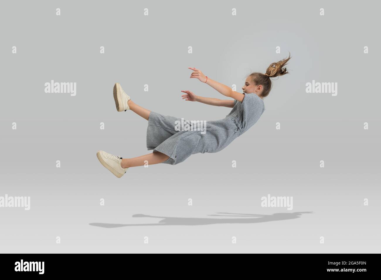Studio shot of little preschool caucasian girl in casual clothes ...