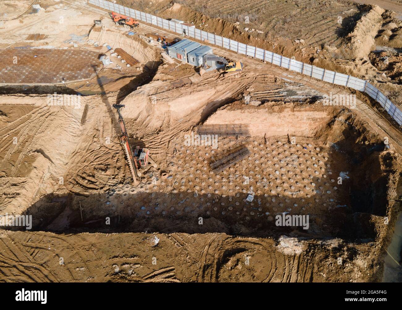 First floor slab rebar installation. Pile driver at construction site ...