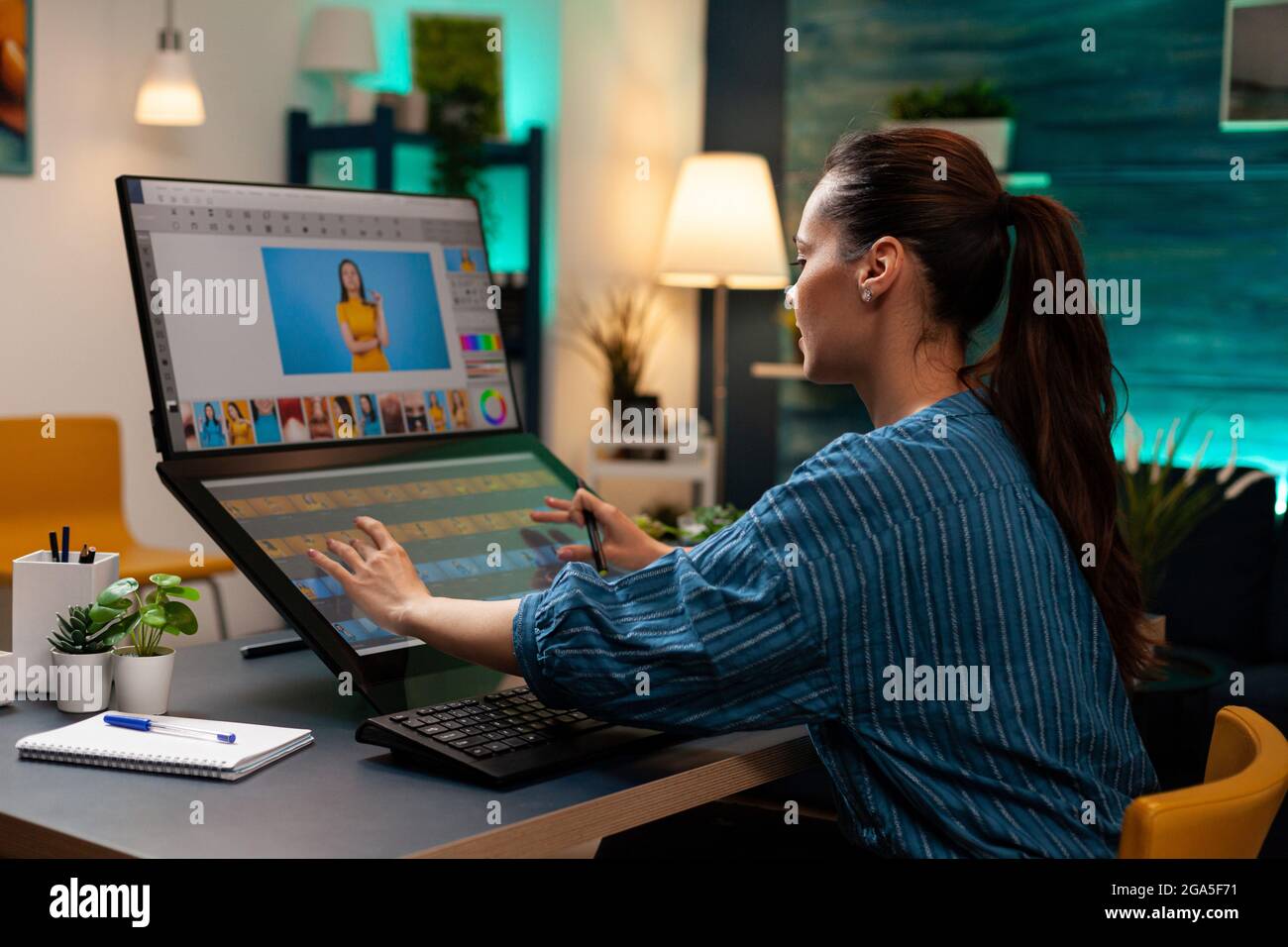 Photo editor artist doing touchpad work on retouching image using ...
