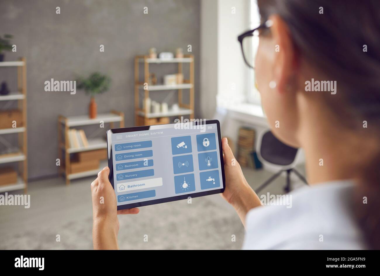Woman controlling system of her Smart House using modern app on her ...