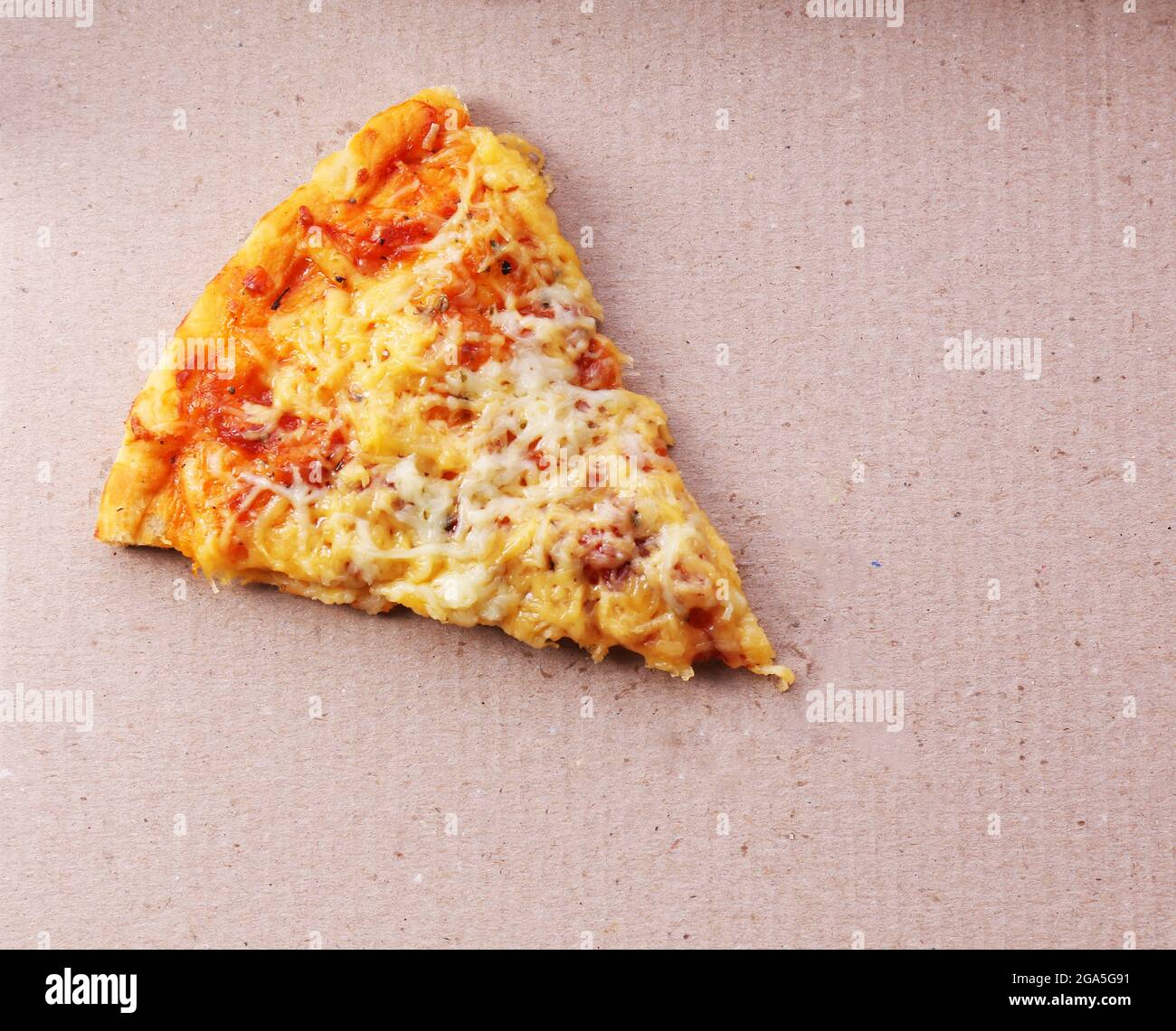 Piece of pizza on cardboard background Stock Photo - Alamy