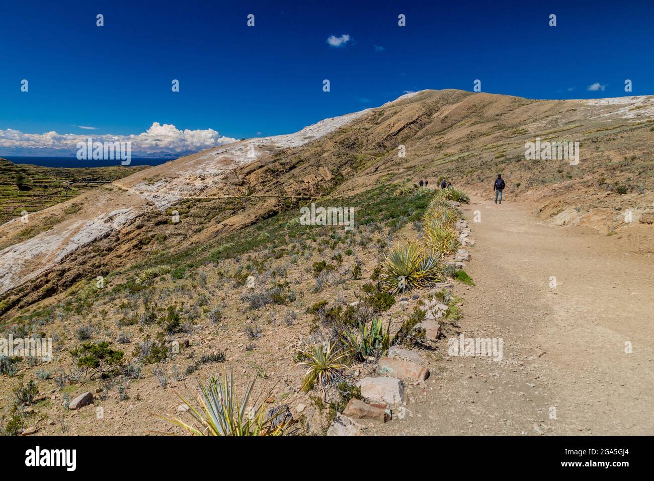 ISLA DEL SOL, BOLIVIA - MAY 12, 2015: Tourists walk on an ancient inca ...