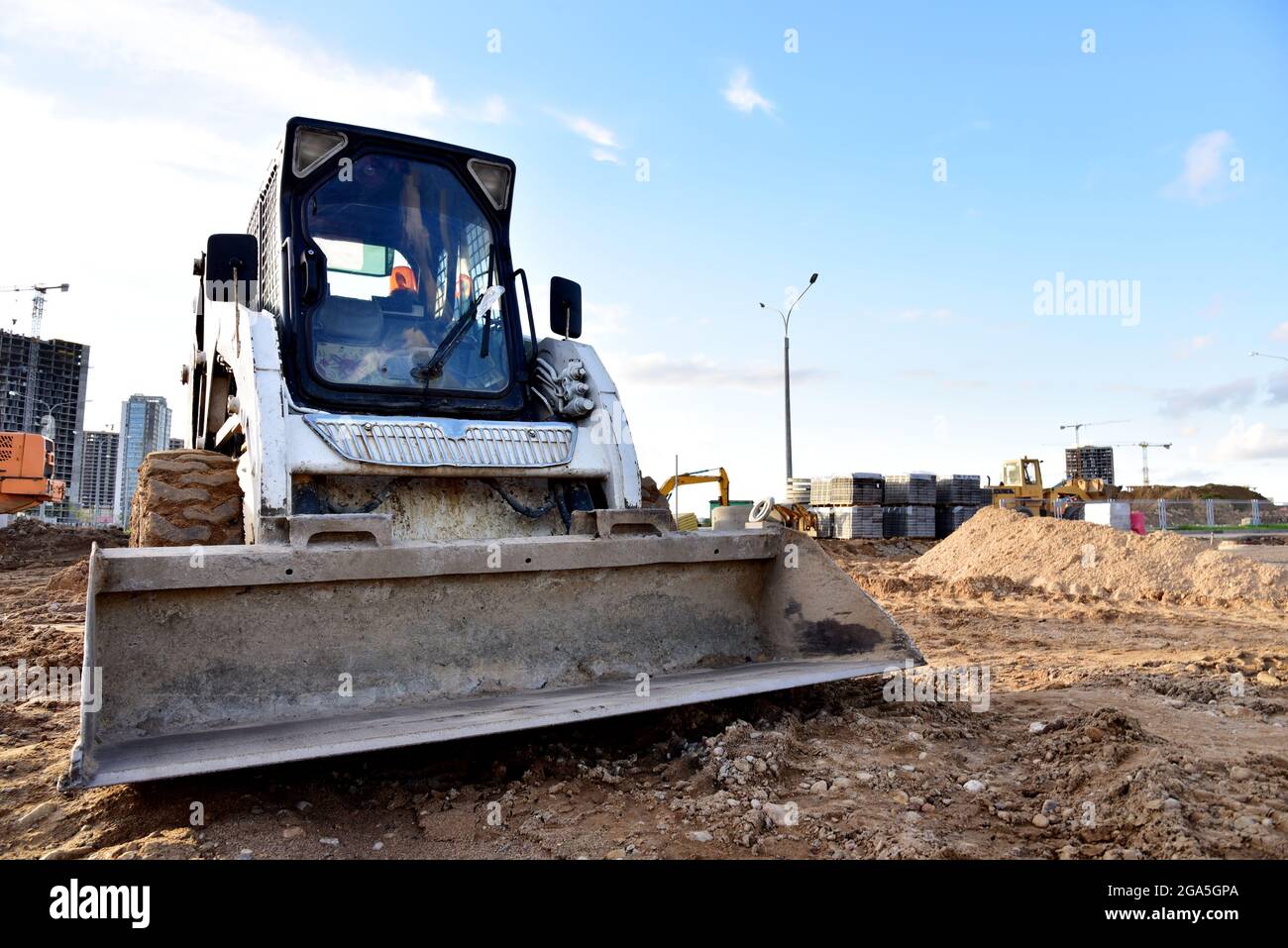 Skid-steer loader for loading and unloading works on city streets ...