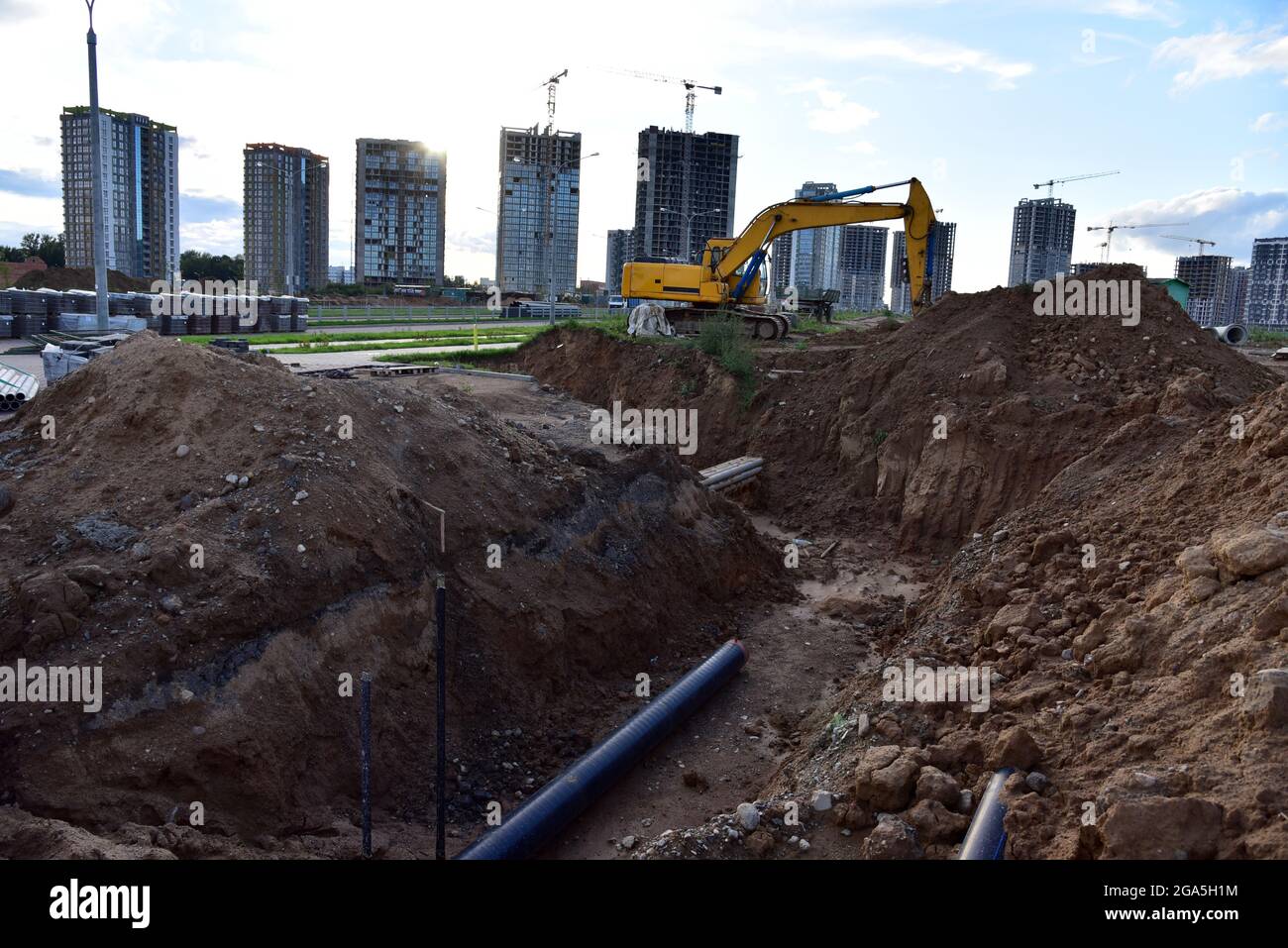 Excavator dig the trenches at a construction site. Trench for laying ...