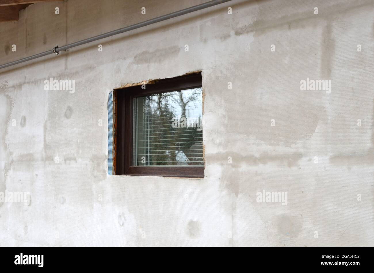 Plastered house wall and window in the wall Stock Photo - Alamy