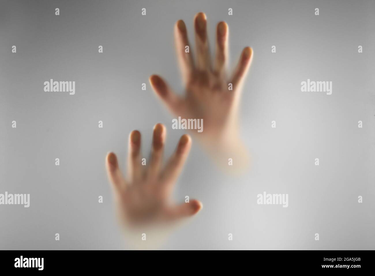 Hands silhouettes behind glass foreground Stock Photo - Alamy