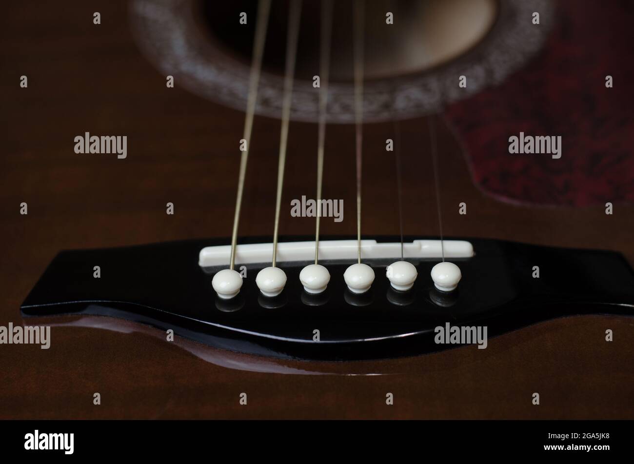 Part of the guitar deck close-up. Guitar bridge Stock Photo - Alamy