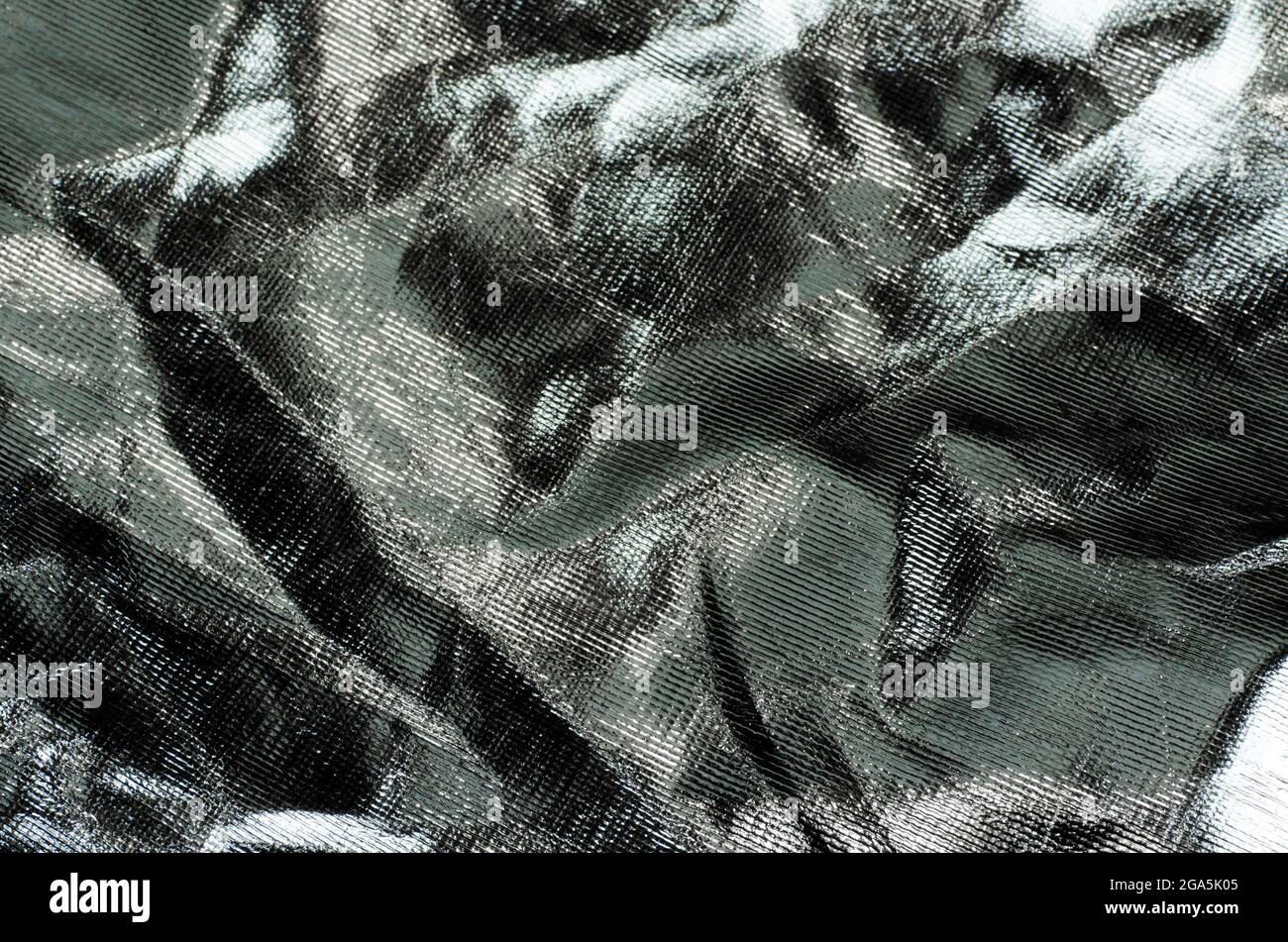 Silvery crumpled shiny material as background. Crumpled silver texture ...