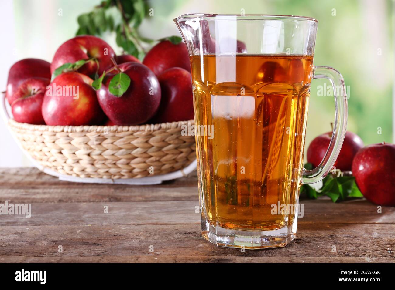 Full jug of apple juice and fruits on bright background Stock Photo - Alamy