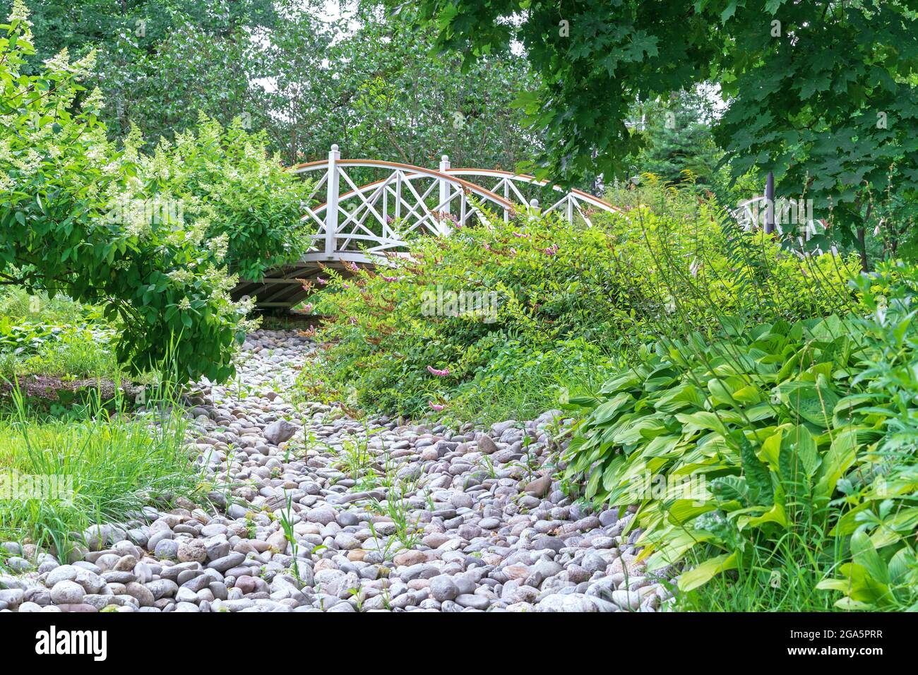 Round wooden bridge over the dry bed of a small river Stock Photo - Alamy