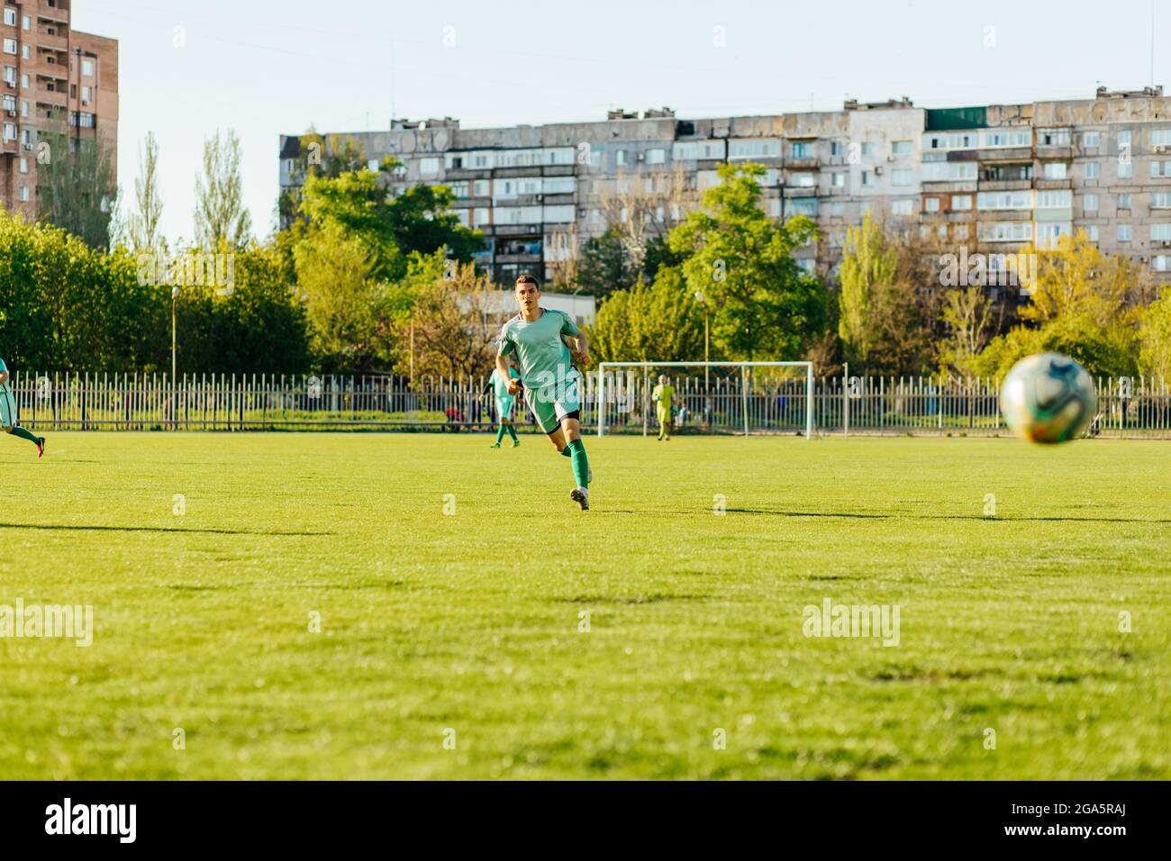 footballer plays a dynamic game in a professional stadium, a group of ...