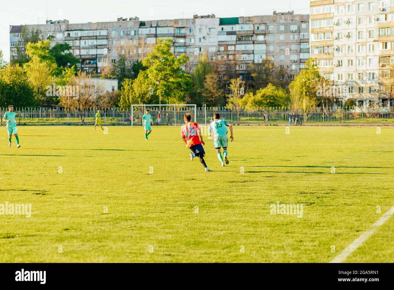 football players in action in the stadium, Football game for adults ...