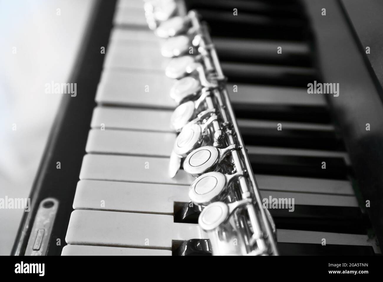 Flute on piano keys, closeup Stock Photo - Alamy