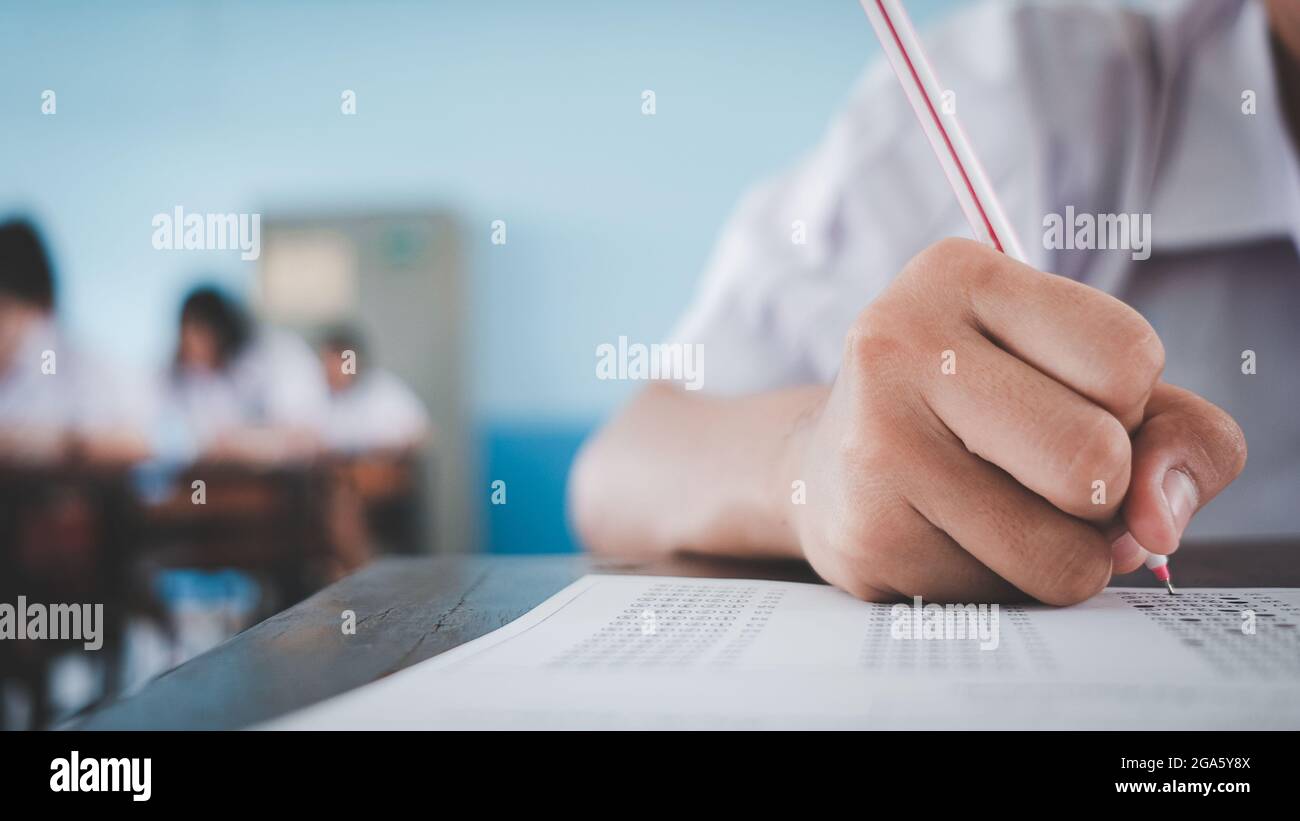 Close up to students writing and reading exam answer sheets exercises ...
