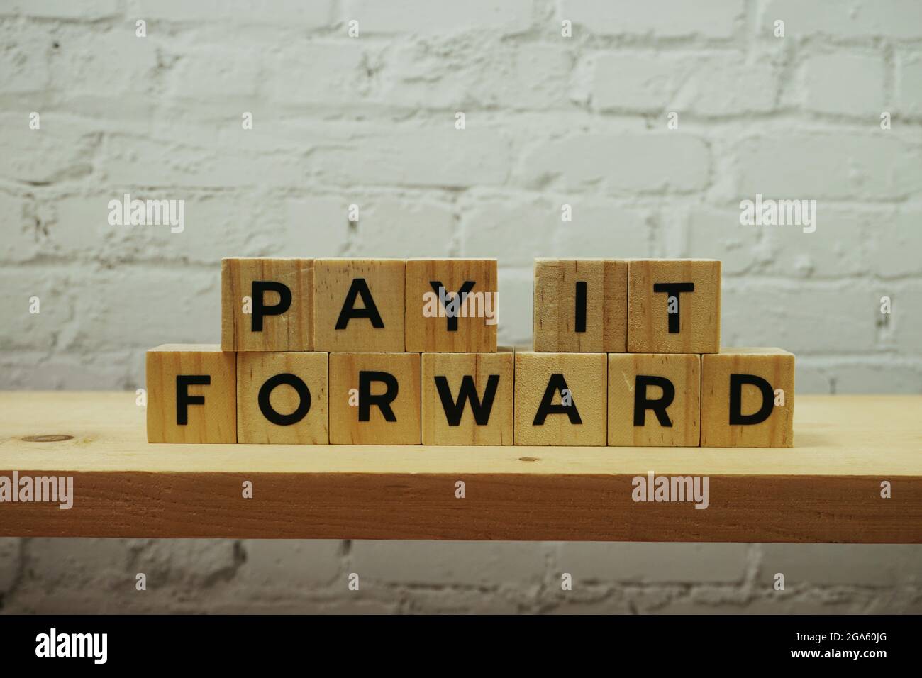 Pay It Forward alphabet letter on wooden background Stock Photo - Alamy