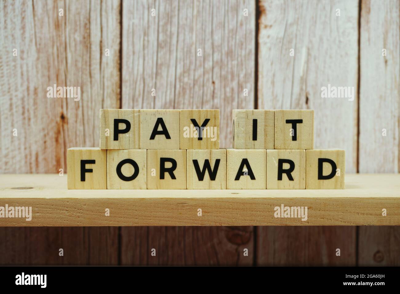 Pay It Forward alphabet letter on wooden background Stock Photo - Alamy