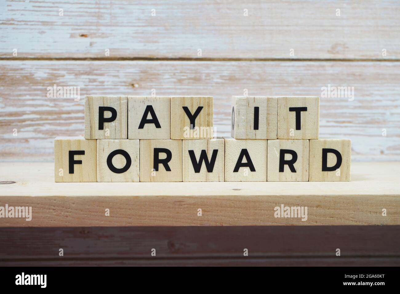 Pay It Forward alphabet letters with space copy on wooden shelf Stock ...