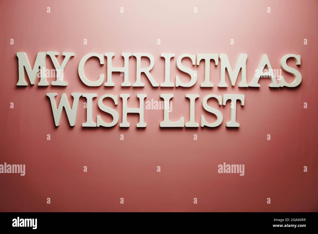 Top view of My Christmas wish list alphabet letters on pink background ...