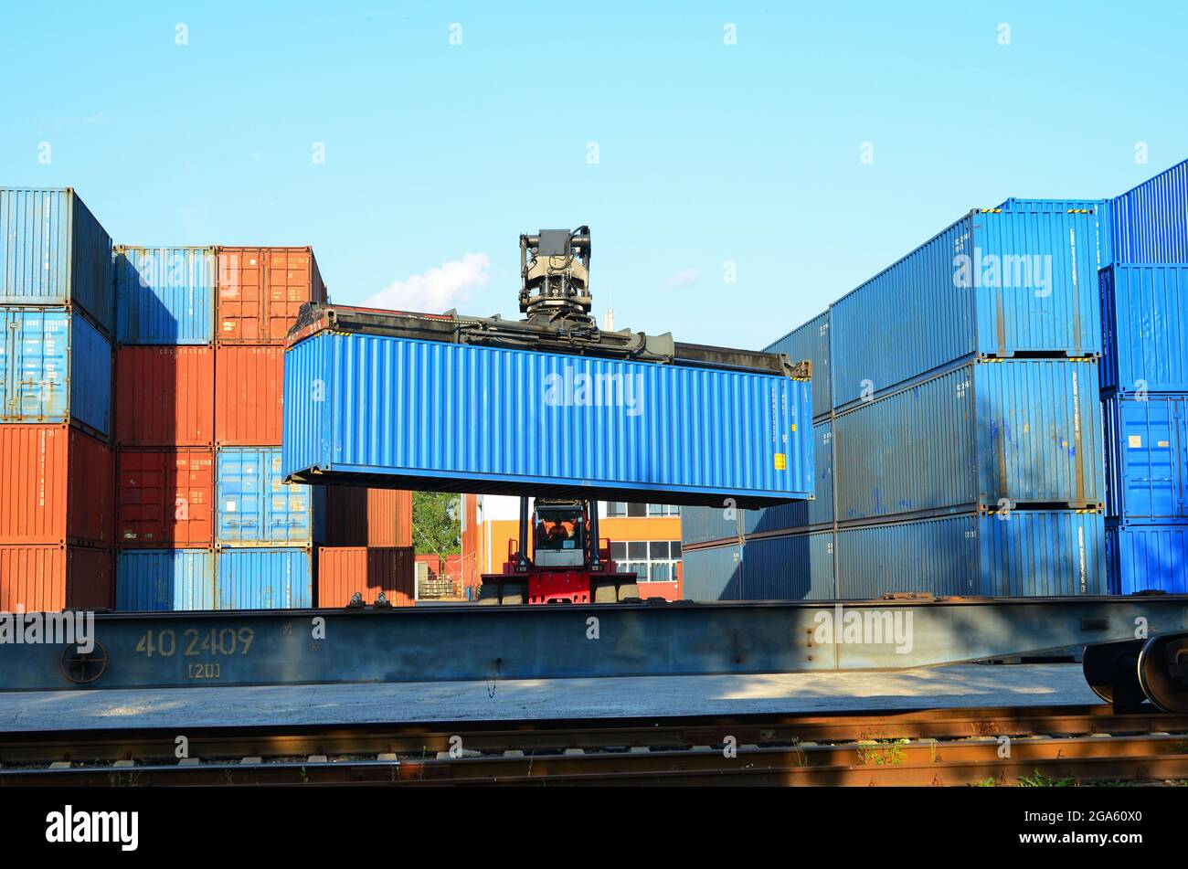 Shipping container loading by richtracker on the freight rail car at ...