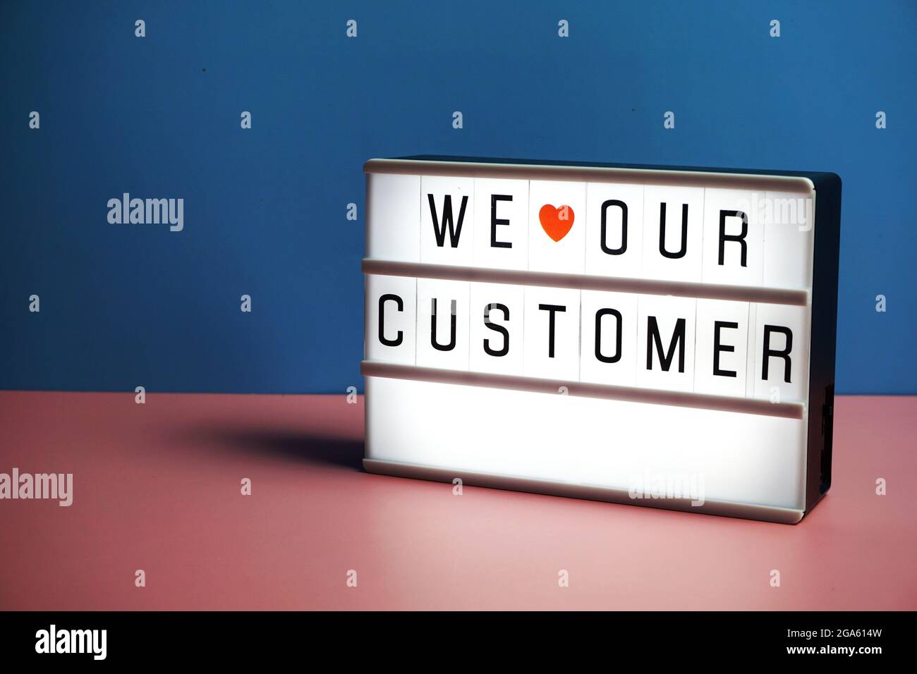 We Love Our Customer text in light box with space copy on pink and blue ...