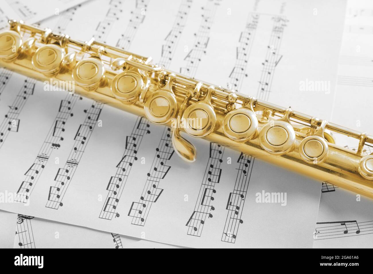Flute on music notes background Stock Photo - Alamy