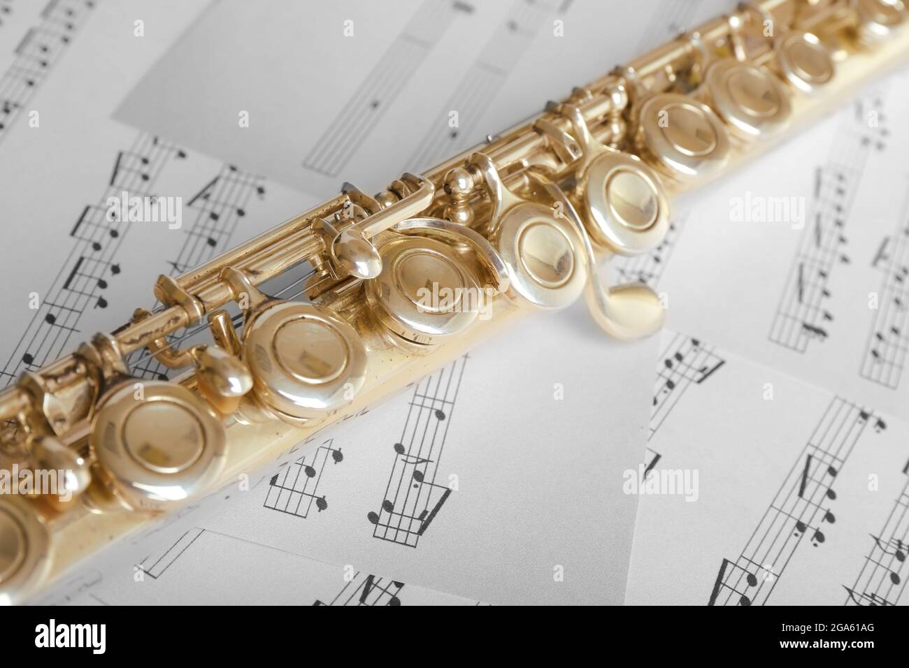Flute on music notes background Stock Photo - Alamy