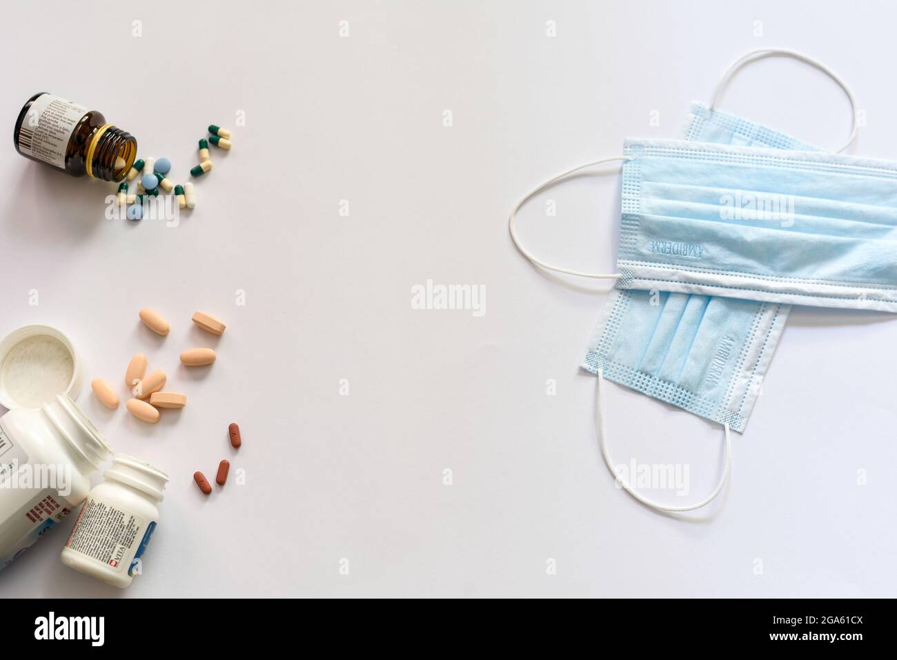 Medication drugs and pills with the surgical masks on a white surface ...
