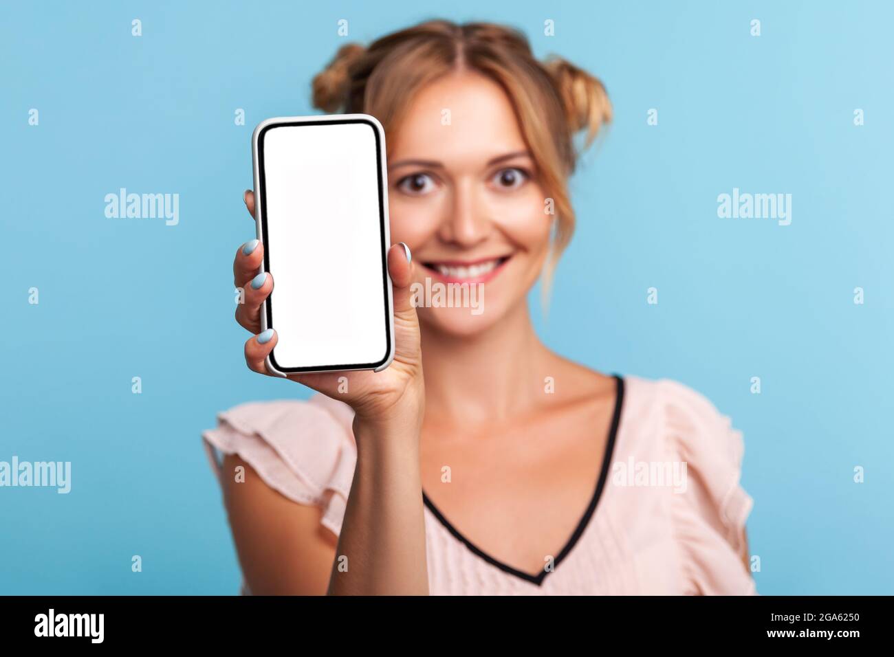 Portrait of blonde woman standing with charming smile, happy expression ...
